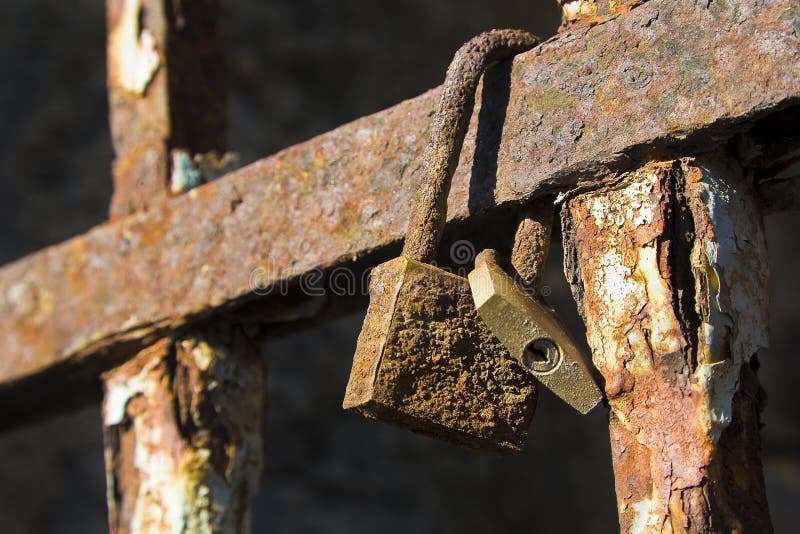 Old, Damaged and Rusty Metal Gate of a Factory Closed with Padlock ...