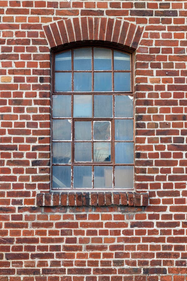Industrial Window with a Metal Rusted Frame on a Red Damaged Brick Wall ...