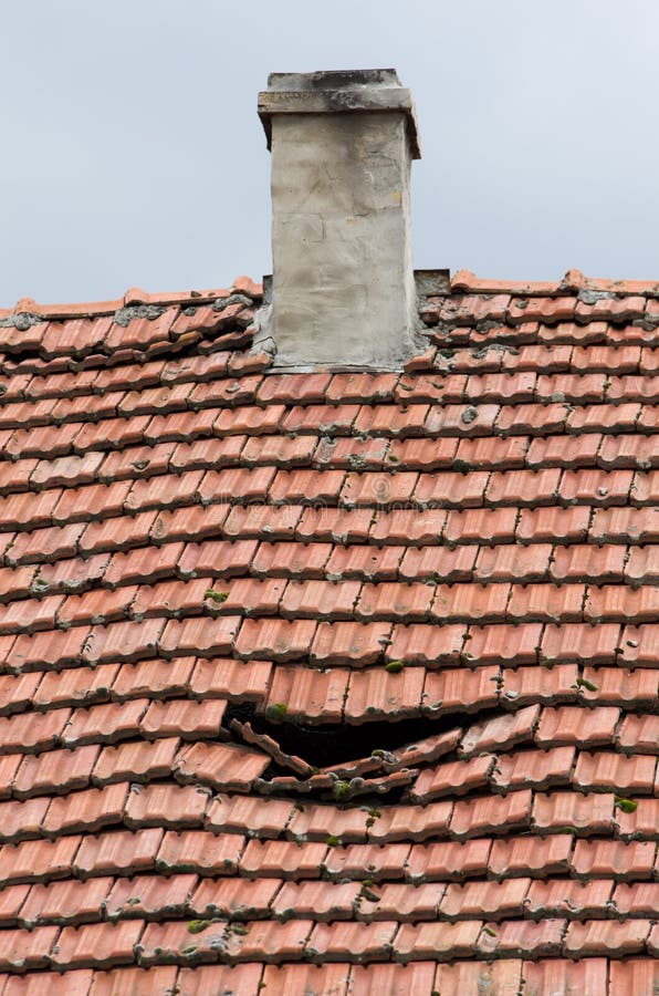 Old Damaged Tiled Roof with a Hole on the Roof and Broken Tiles Stock ...