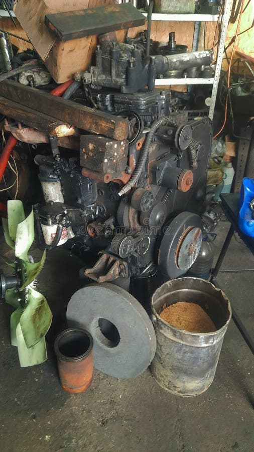 Old Diesel Engine in a Cluttered Workshop during the Day with Various ...