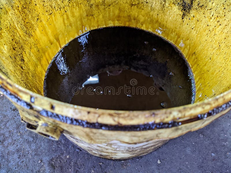 Old Dirty Bucket with Used Engine Oil in the Garage. Stock Image ...