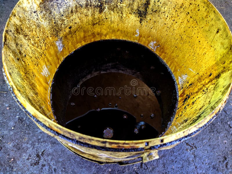 Old Dirty Bucket with Used Engine Oil in the Garage. Stock Photo ...