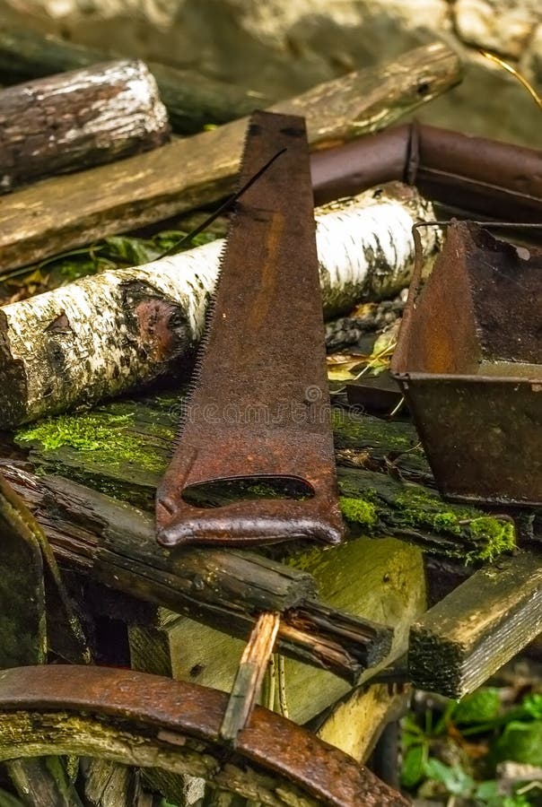 Old Discarded Things. Rusty Hacksaw and Bread Baking Dish Stock Image ...