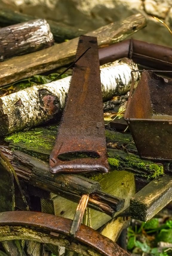 Old Discarded Things. Rusty Hacksaw and Bread Baking Dish Stock Image ...