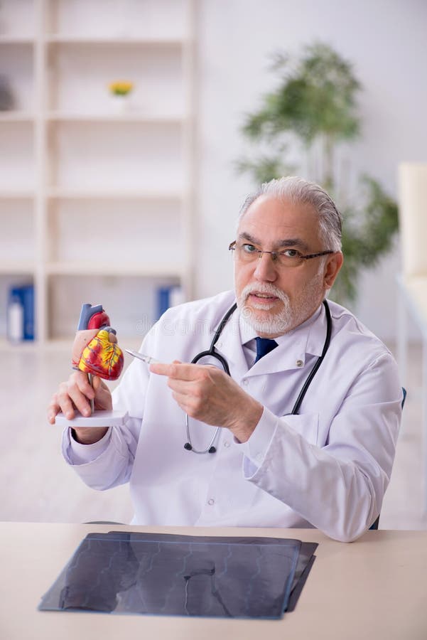 Old Male Doctor Cardiologist Working in the Clinic Stock Photo - Image ...