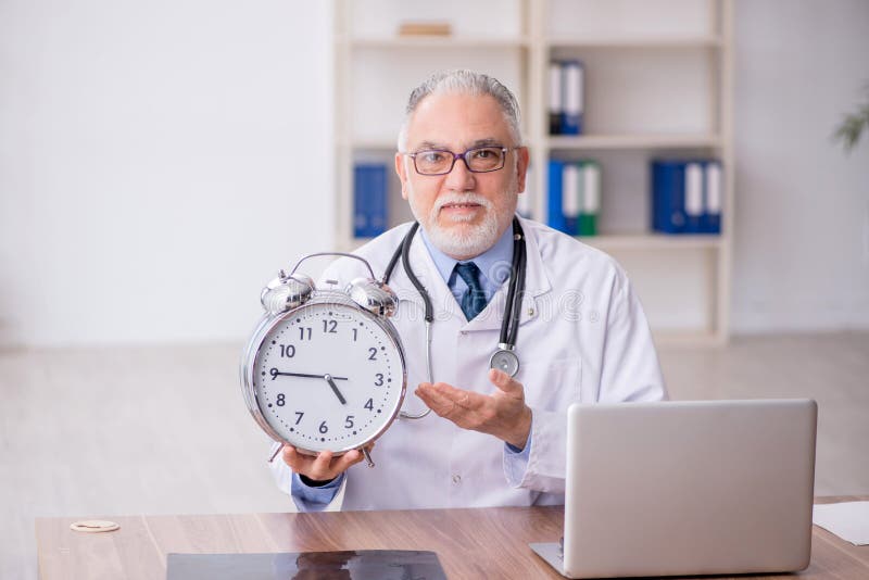 Old Male Doctor in Time Management Concept Stock Image - Image of ...