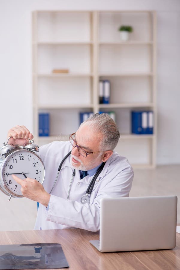 Old Male Doctor in Time Management Concept Stock Photo - Image of ...