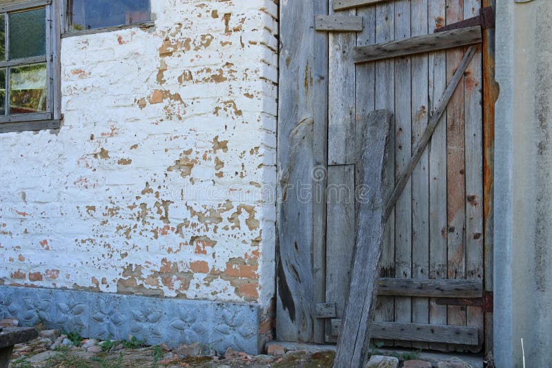 An Old Door Made of Planks is Propped Up with a Stick Stock Photo ...