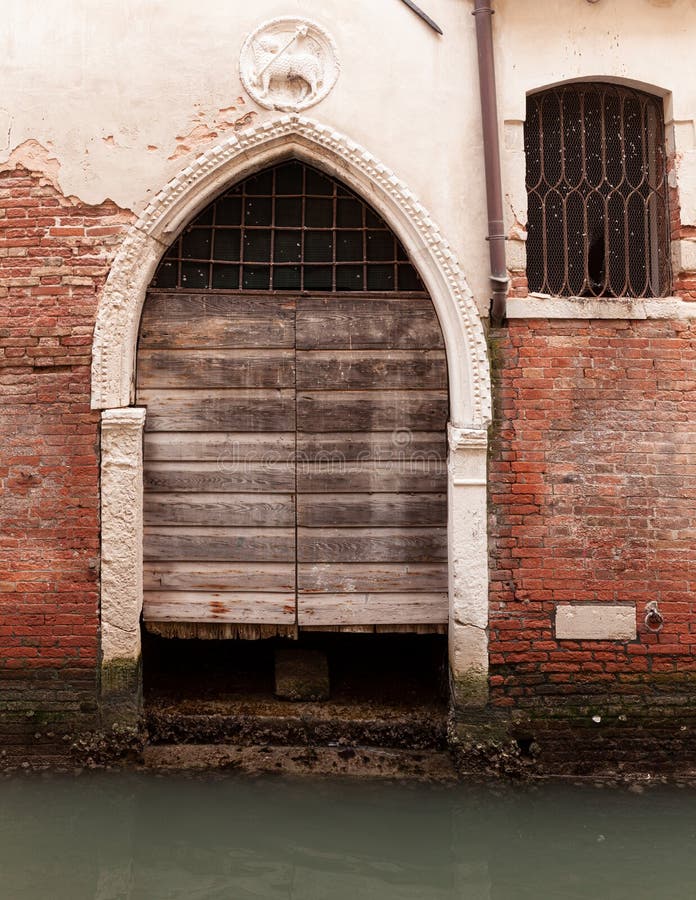 Old door in Venice canal stock image. Image of europa - 255628717