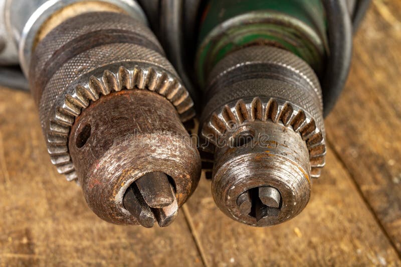 Old Drills on a Wooden Workshop Table. Rusty Drill Holder in an Old ...