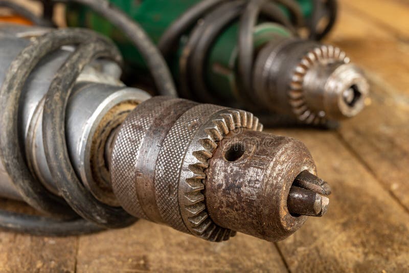 Old Drills on a Wooden Workshop Table. Rusty Drill Holder in an Old ...