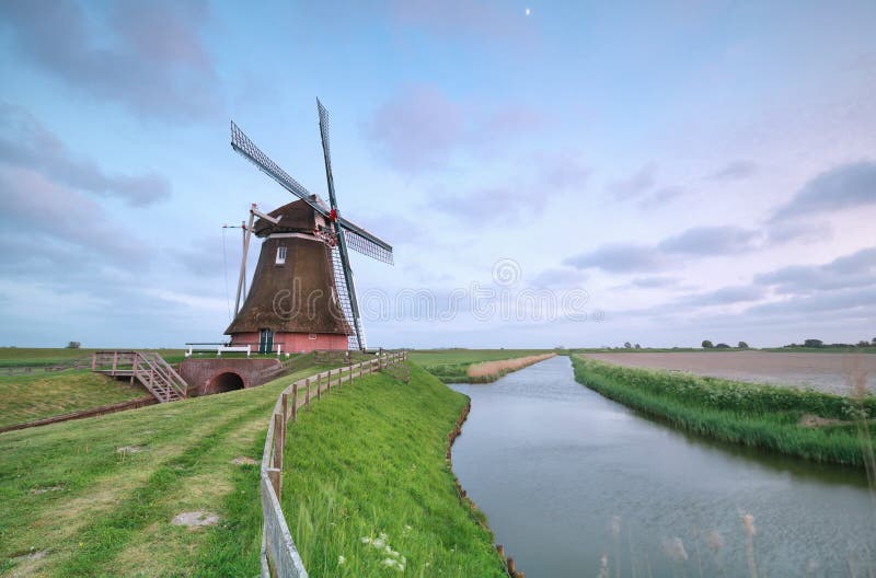Old Dutch Windmill On Canal Stock Image - Image of netherlands, holland ...