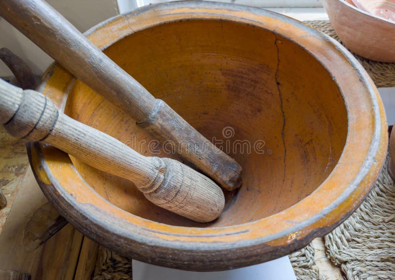 Old Earthenware Kitchen Mortar and Two Wooden Pestles in it Stock Image ...