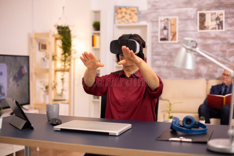 Old Elderly Woman Using a VR Virtual Reality Headset for the First Time ...