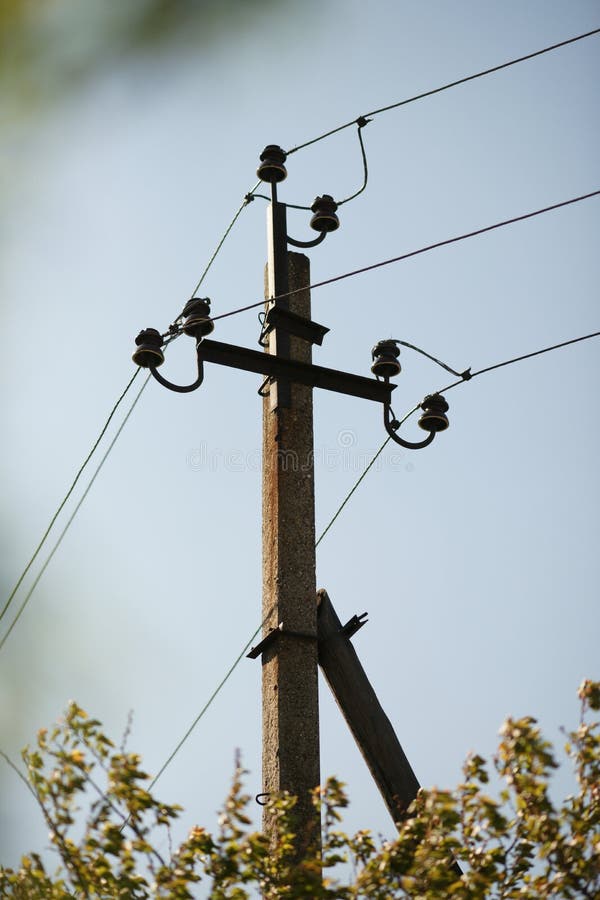 Old Electric Post on a Background of Blue Sky and Trees with Lea Stock ...