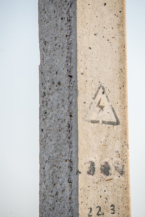 An Old Electric Shock Warning Sign on a Concrete Pillar Stock Photo ...