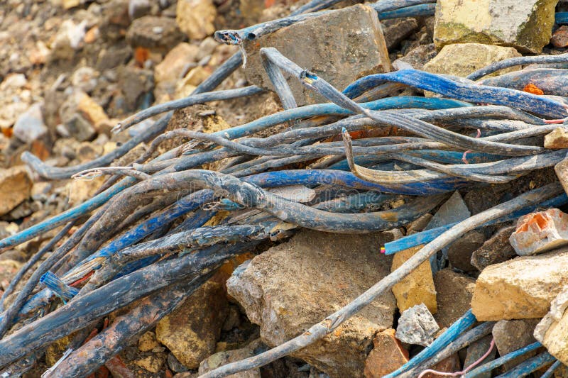 An Old Electrical Cable Sticks Out of the Ground Against a Backdrop of ...