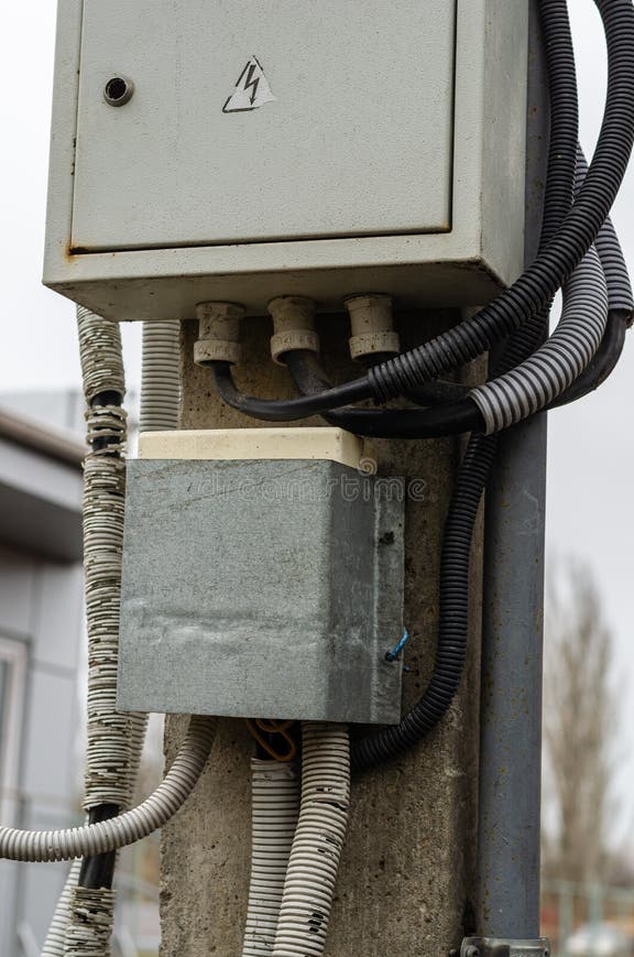 An Old Electrical Panel, a Rusty Metal Box Hangs on the Shield of an ...