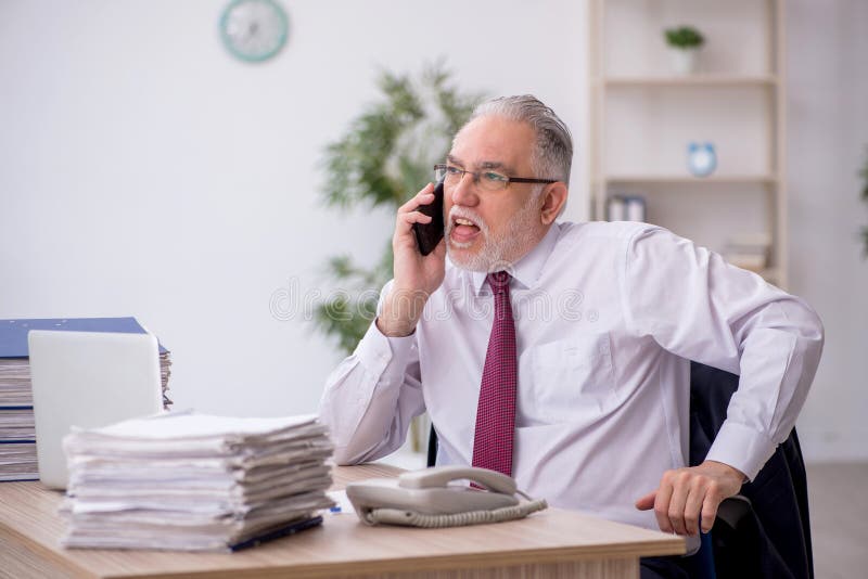 Old Male Employee Speaking by Phone at Workplace Stock Photo - Image of ...