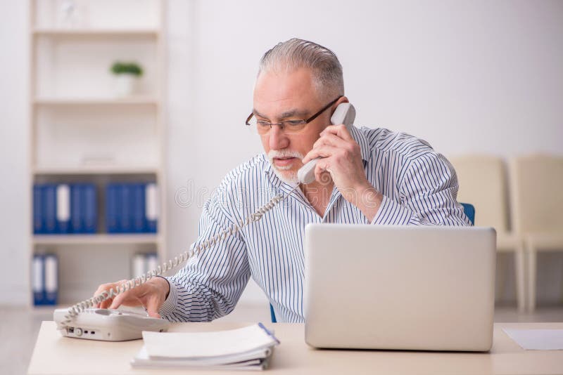 Old Male Employee Working at Workplace Stock Image - Image of busy ...