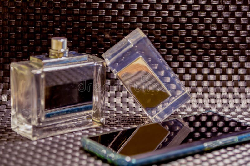 Old Empty Perfume Bottle on a Dark Surface and a Cell Phone Next To it ...