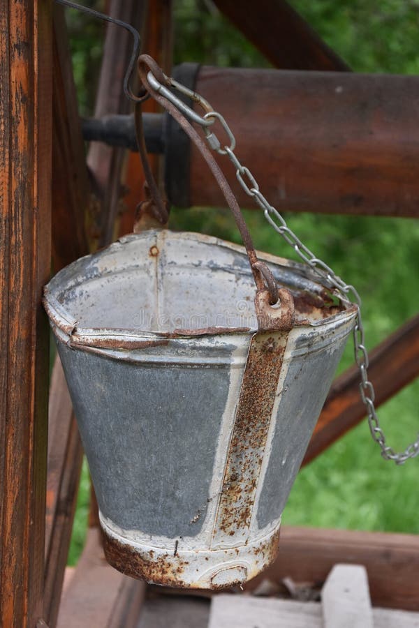 Empty Steel Bucket Standing Upright on a Closed Well Stock Photo ...