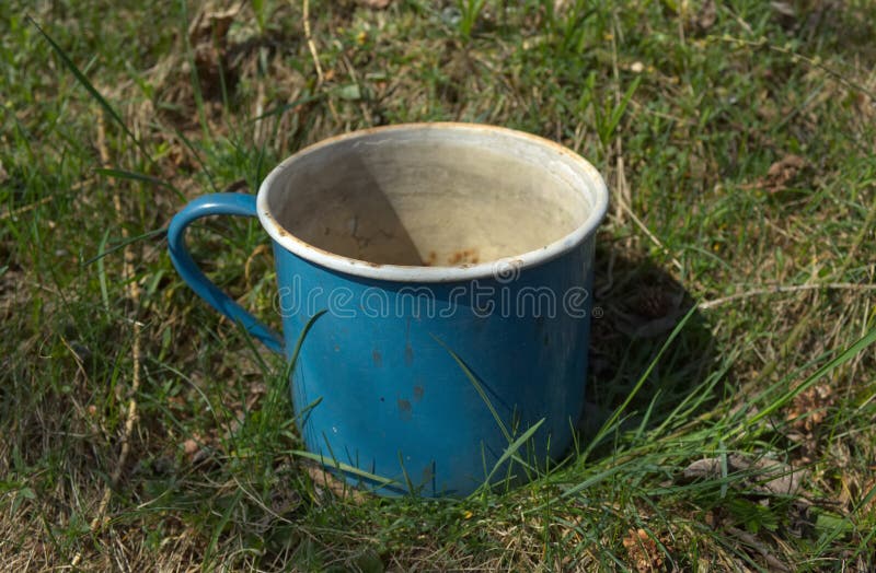 Old Enamel Metal Battered Mug Grass Garden Stock Image - Image of ...