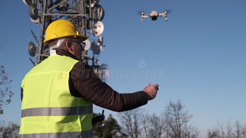 Civil Engineer Operating a Drone with Remote Control Lands the Drone at ...