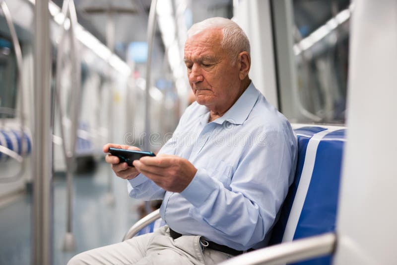 Old Man with Smartphone Sitting Inside Subway Train Stock Photo - Image ...