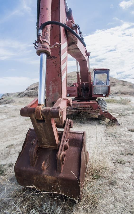 Old excavator on a field stock photo. Image of system - 201302478