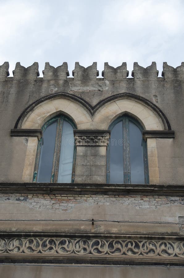 Old Facade with Arched Double Window and Battlements in Italy Stock ...