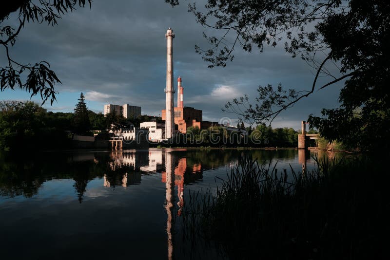 The Old Factory with Smoking Chimneys on the Banks of the River Stock ...