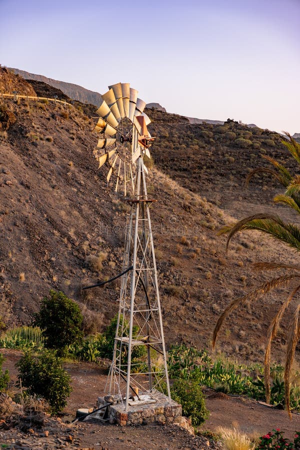 Old Farm Style Water Pumping Windmill at Sunset Stock Photo - Image of ...