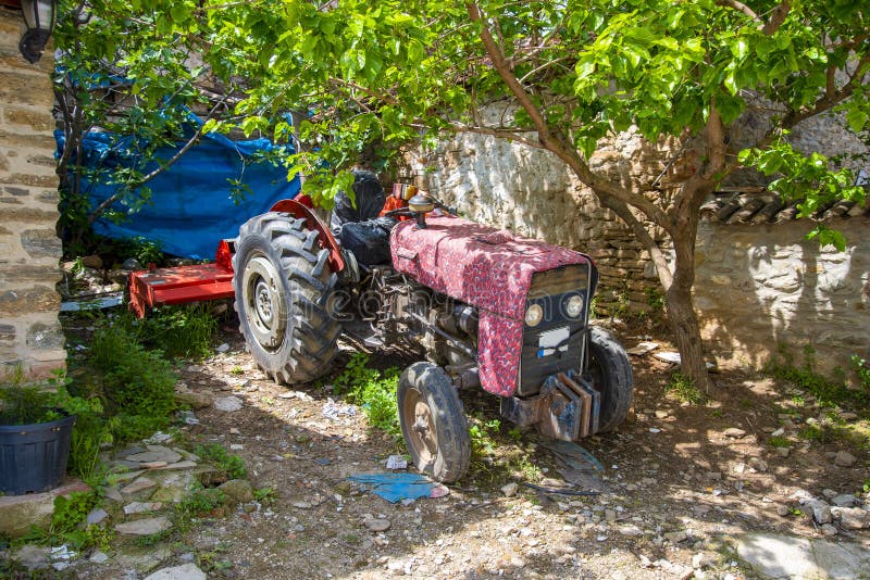 An Old Farm Tractor, Standing in the Bushes Editorial Photo - Image of ...