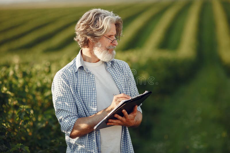 Old Farmer in Shirt Standing on Field with Notebook Stock Photo - Image ...