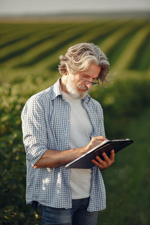 Old Farmer in Shirt Standing on Field with Notebook Stock Photo - Image ...