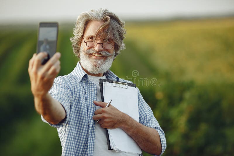 Old Farmer in Shirt Standing on Field with Notebook Stock Image - Image ...