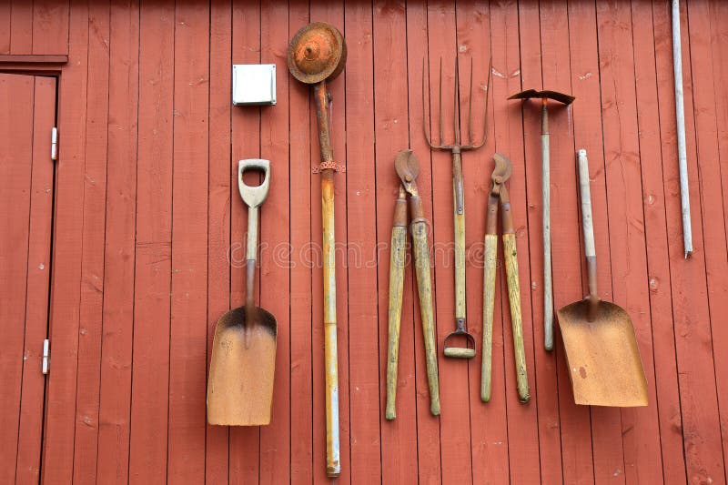 Old Farming Tools Hanging on a Barn Wall Stock Photo - Image of ...