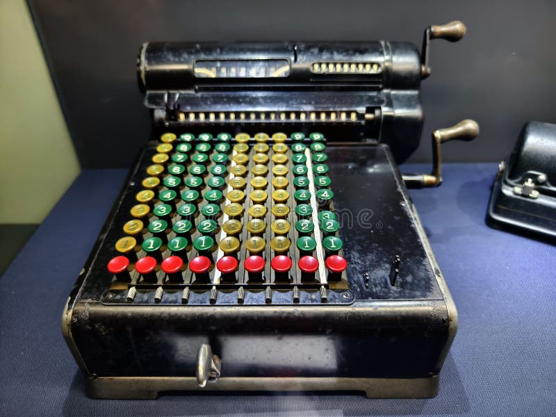 An Old Fashioned Adding Machine Features a Drawer Located Underneath it ...