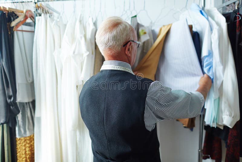 Old Fashioned Artisan Looking at Garments in Tailoring Studio Stock ...