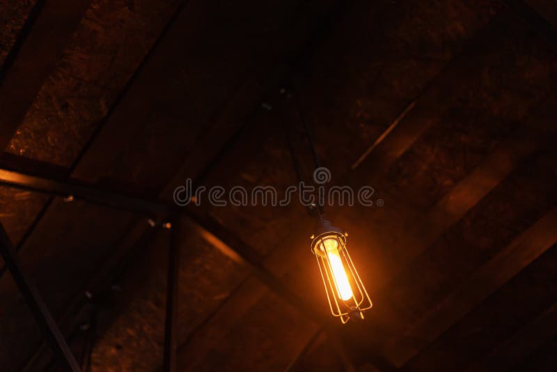 An Old-fashioned Incandescent Light Bulb Hangs from the Ceiling Stock ...