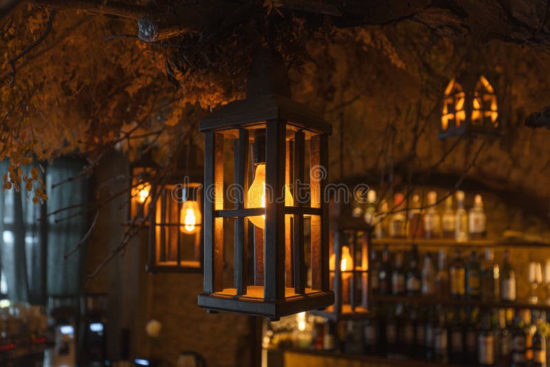 Old Fashioned Lantern with Glowing Lamp in Empty Pub Stock Photo ...