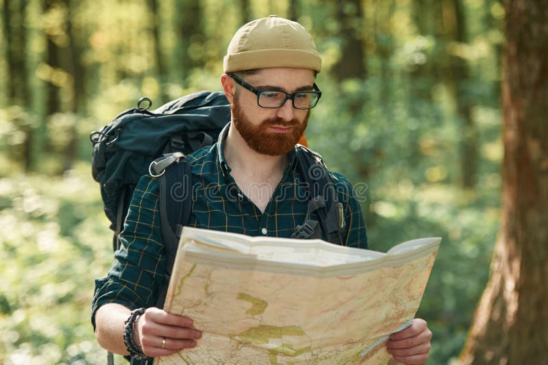 Old Fashioned Paper Map in Hands. Bearded Man is in the Forest at ...