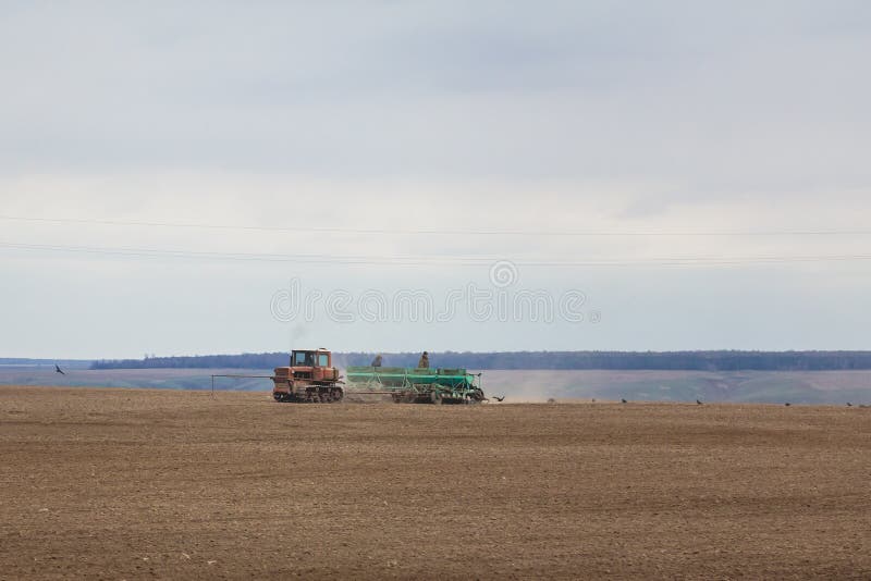 Old-fashioned Tractor Sowing Crops at Field Stock Photo - Image of ...