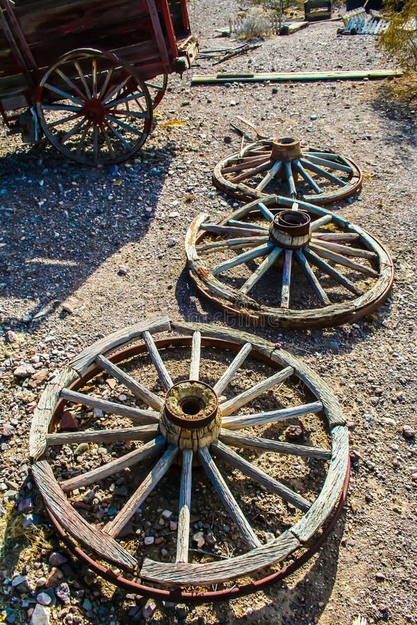 Old-fashioned Wagon Wheels Next To a Large Wagon Stock Photo - Image of ...