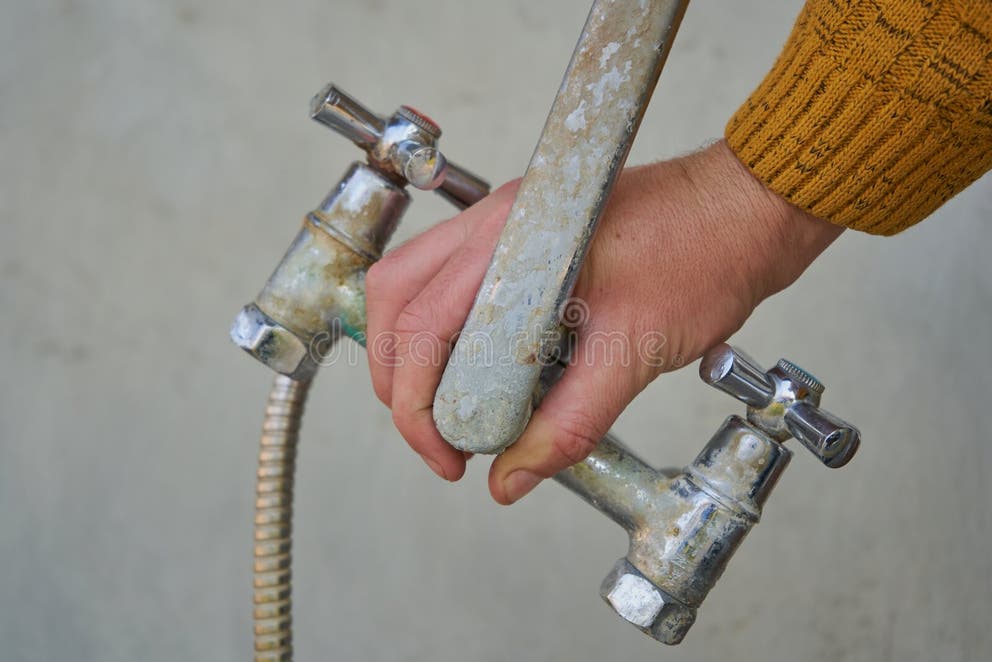The Old Faucet is Covered with Plaque, in the Hands a Broken Faucet ...
