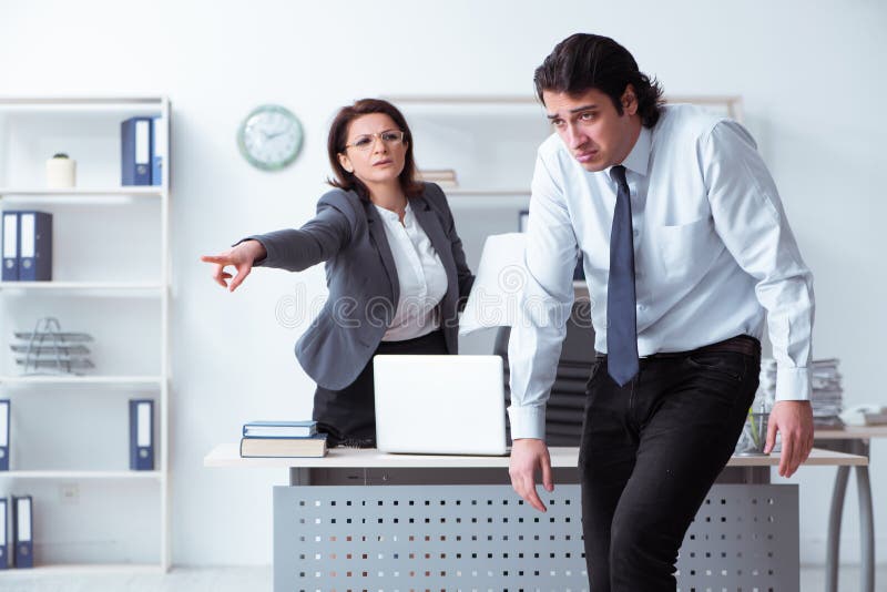 Old Female Boss and Young Male Employee in the Office Stock Photo ...