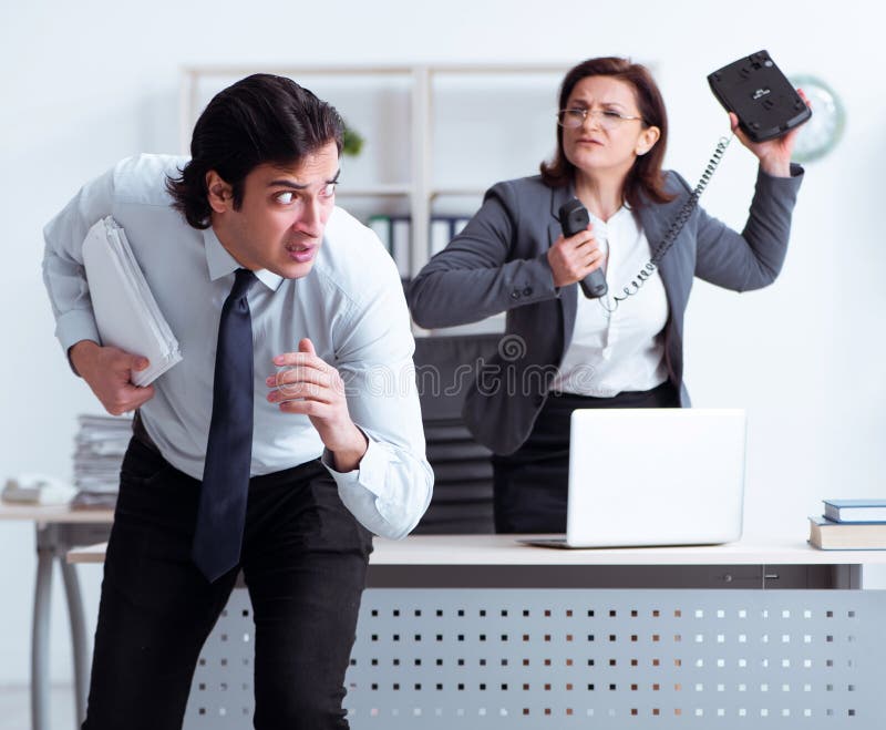 Old Female Boss and Young Male Employee in the Office Stock Image ...