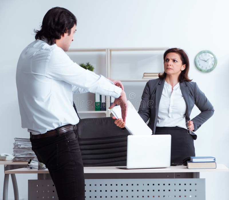 Old Female Boss and Young Male Employee in the Office Stock Image ...