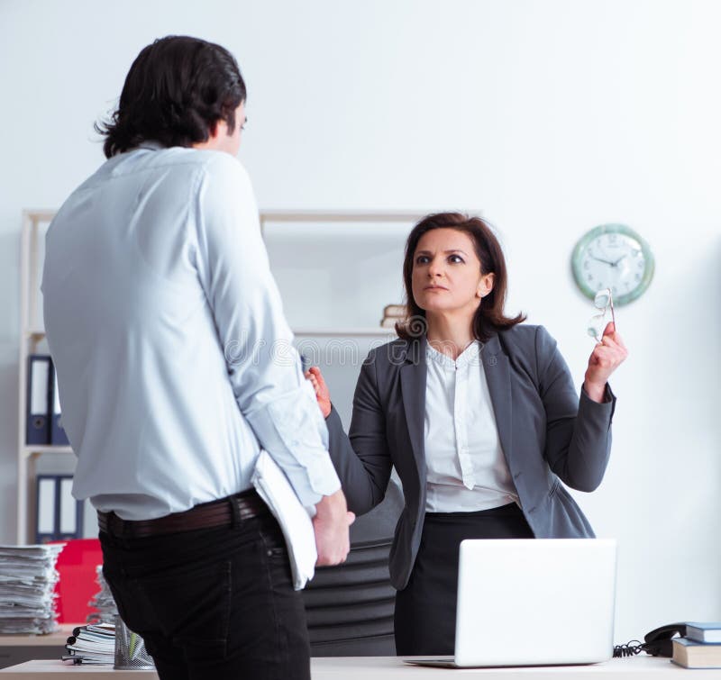 Old Female Boss and Young Male Employee in the Office Stock Photo ...